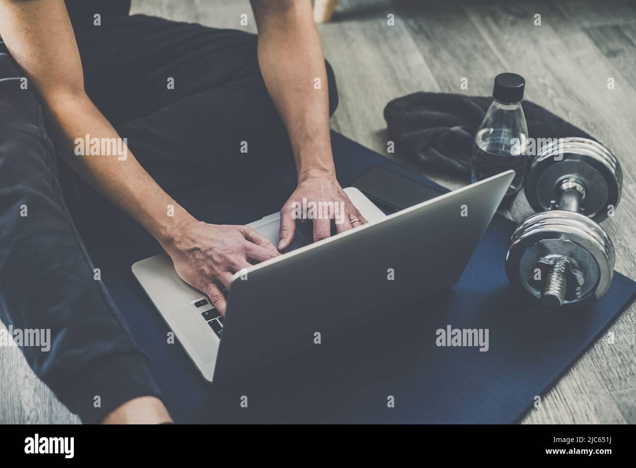 Sporty man resting after working out at home. Fit boy looking gym ...