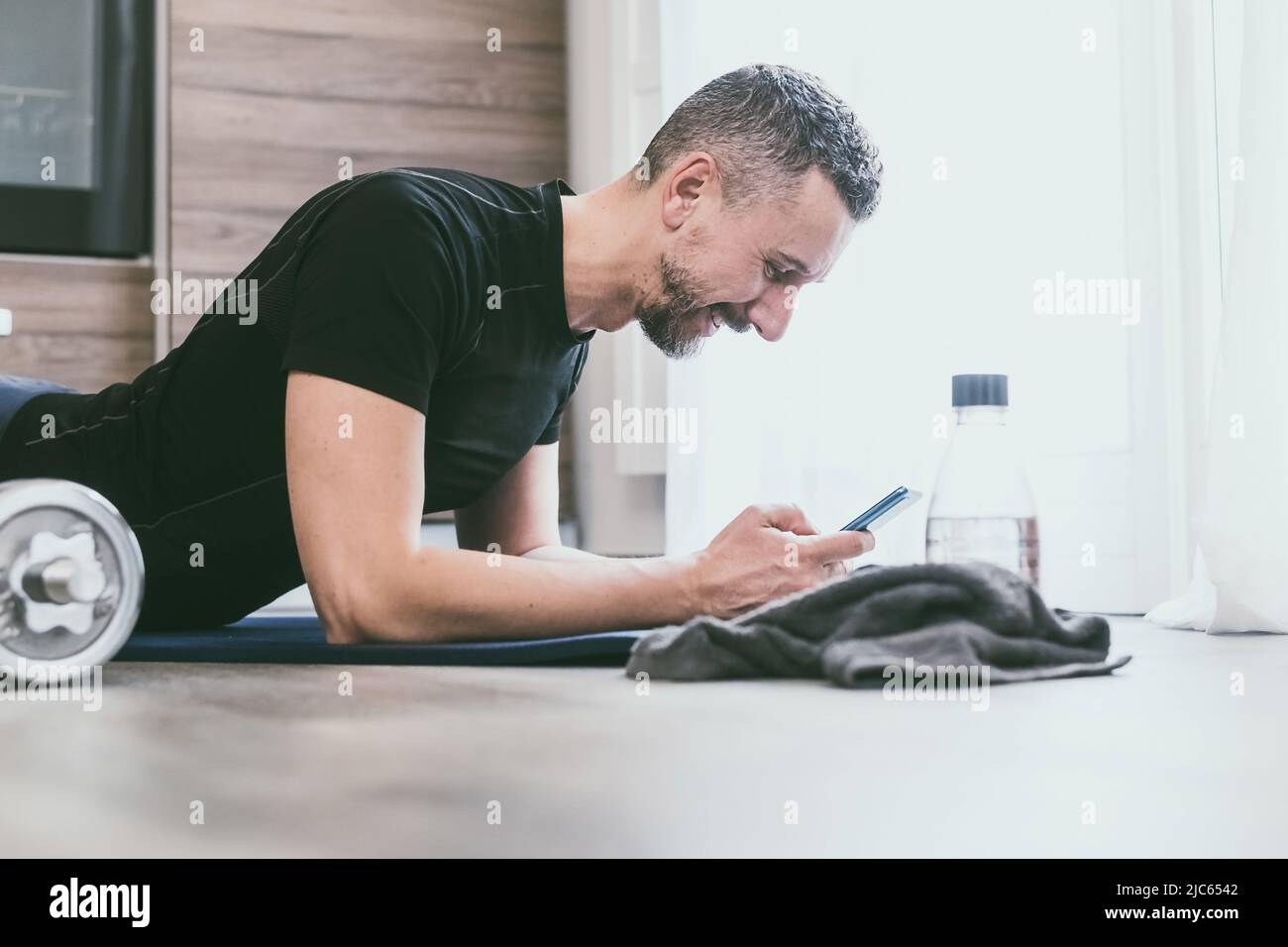 Sporty man resting after working out at home. Fit boy looking gym ...