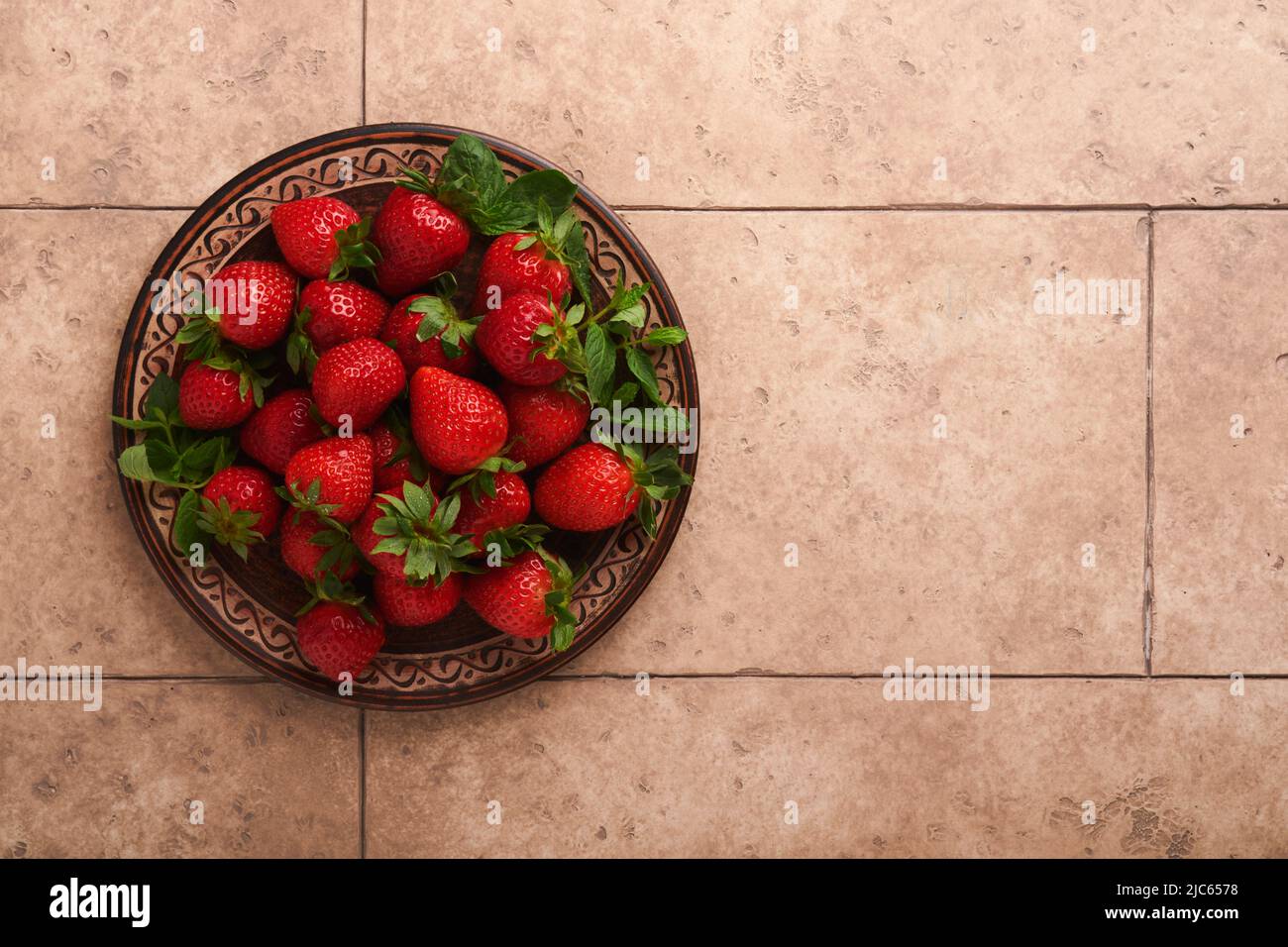 Strawberry berry. Fresh red strawberry in ceramic rustic plate on an ...