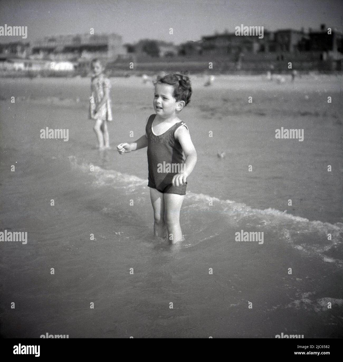 1950s, historical, small boy in a swimming costume of the era, standing ...