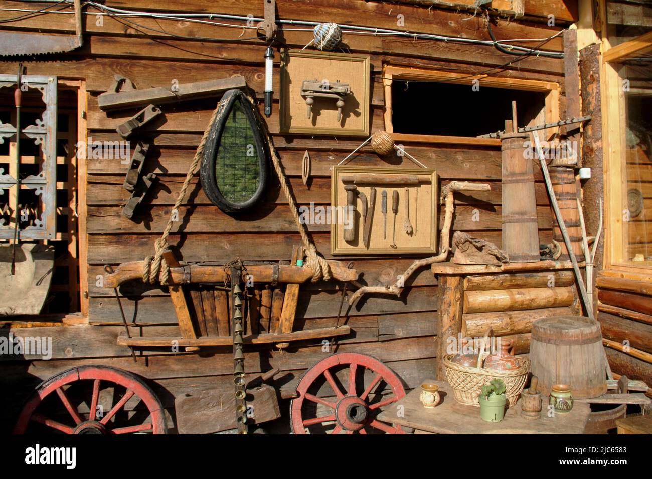 Arrangement of old traditional folk items on the exterior of a barn in ...