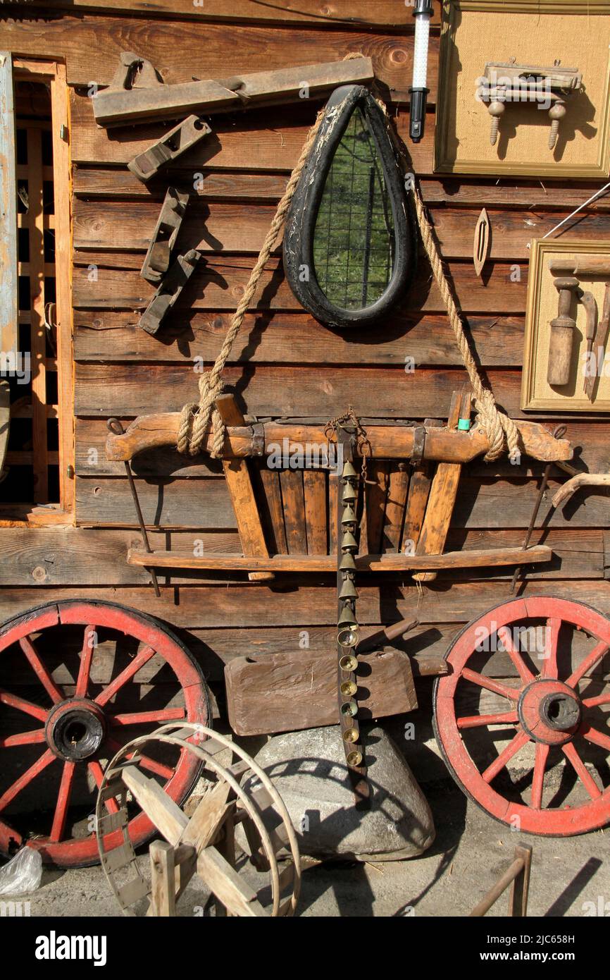 Arrangement of old traditional folk items on the exterior of a barn in ...