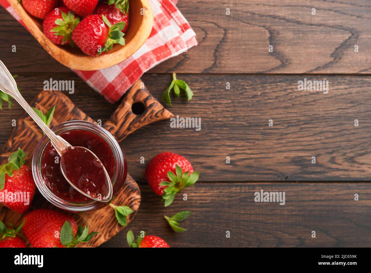 Strawberry jam. Strawberry jam in glass jar with fresh berries plate on ...