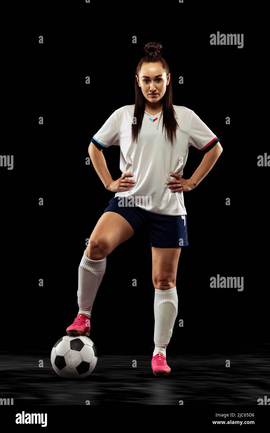 Full-length portrait of sportive girl, female soccer, football player ...