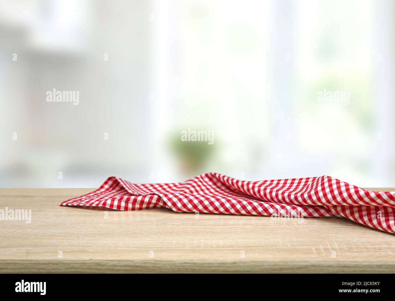 Empty table decorated with red checkered towel food advertisement ...