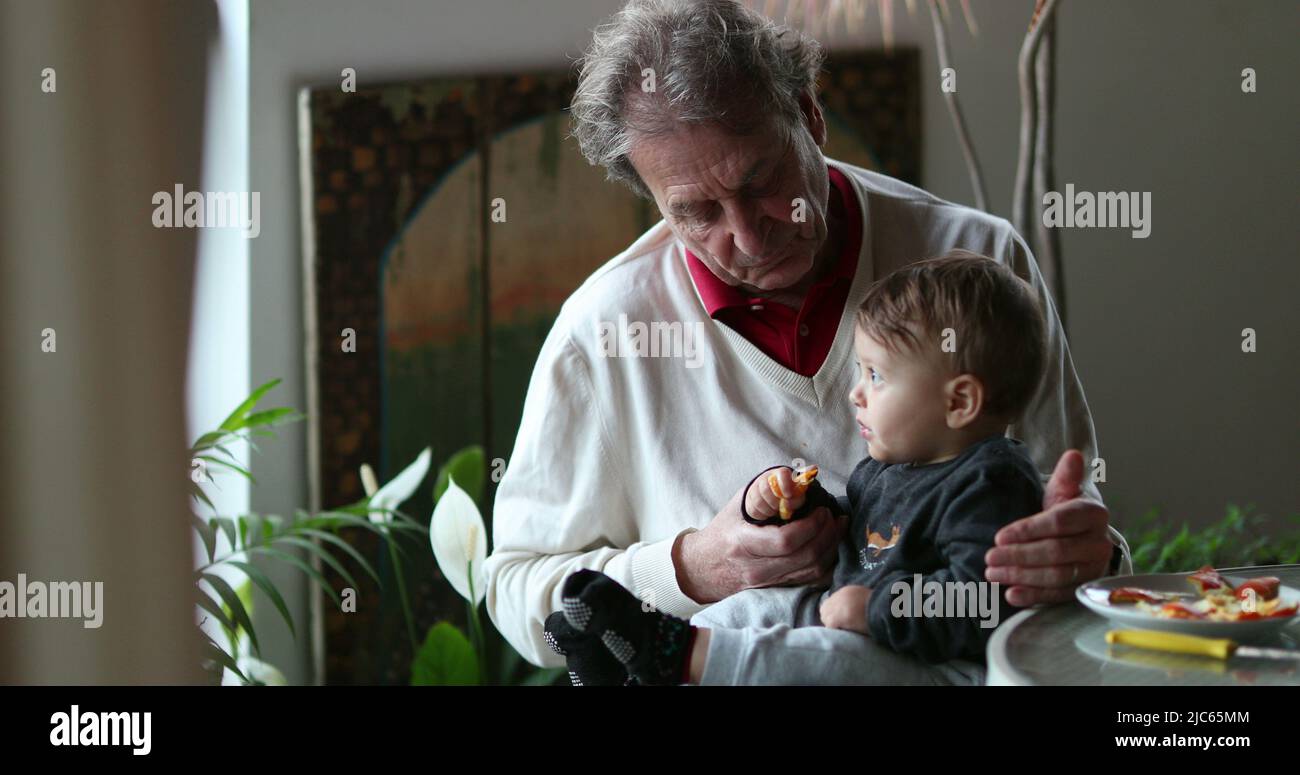 Casual candid grand-father with grandson baby at balcony Stock Photo ...