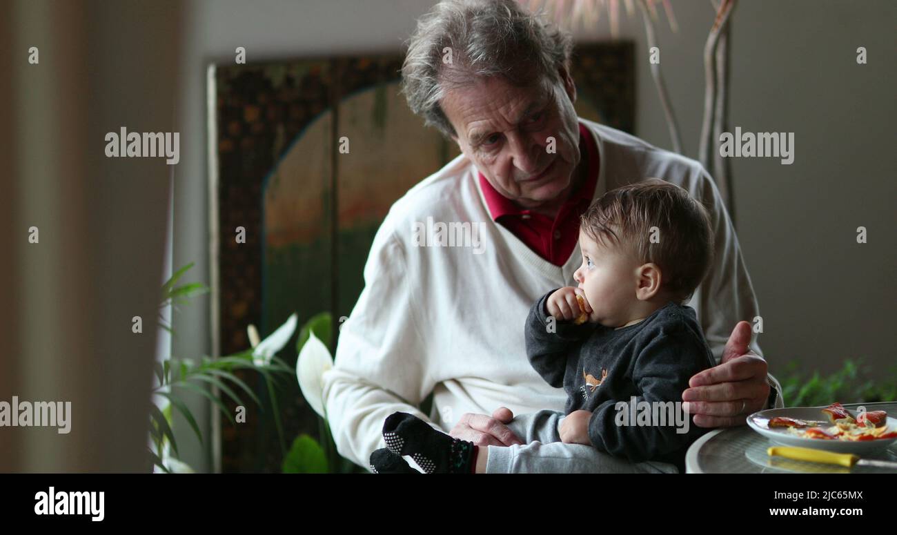 Casual candid grand-father with grandson baby at balcony Stock Photo ...