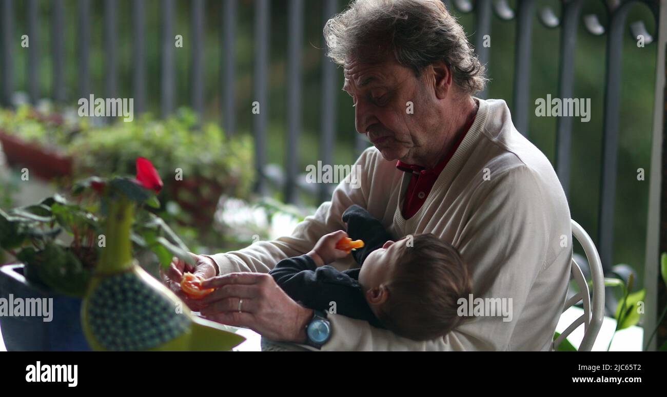 Casual grandfather with grandson baby at home. Candid real life grand ...