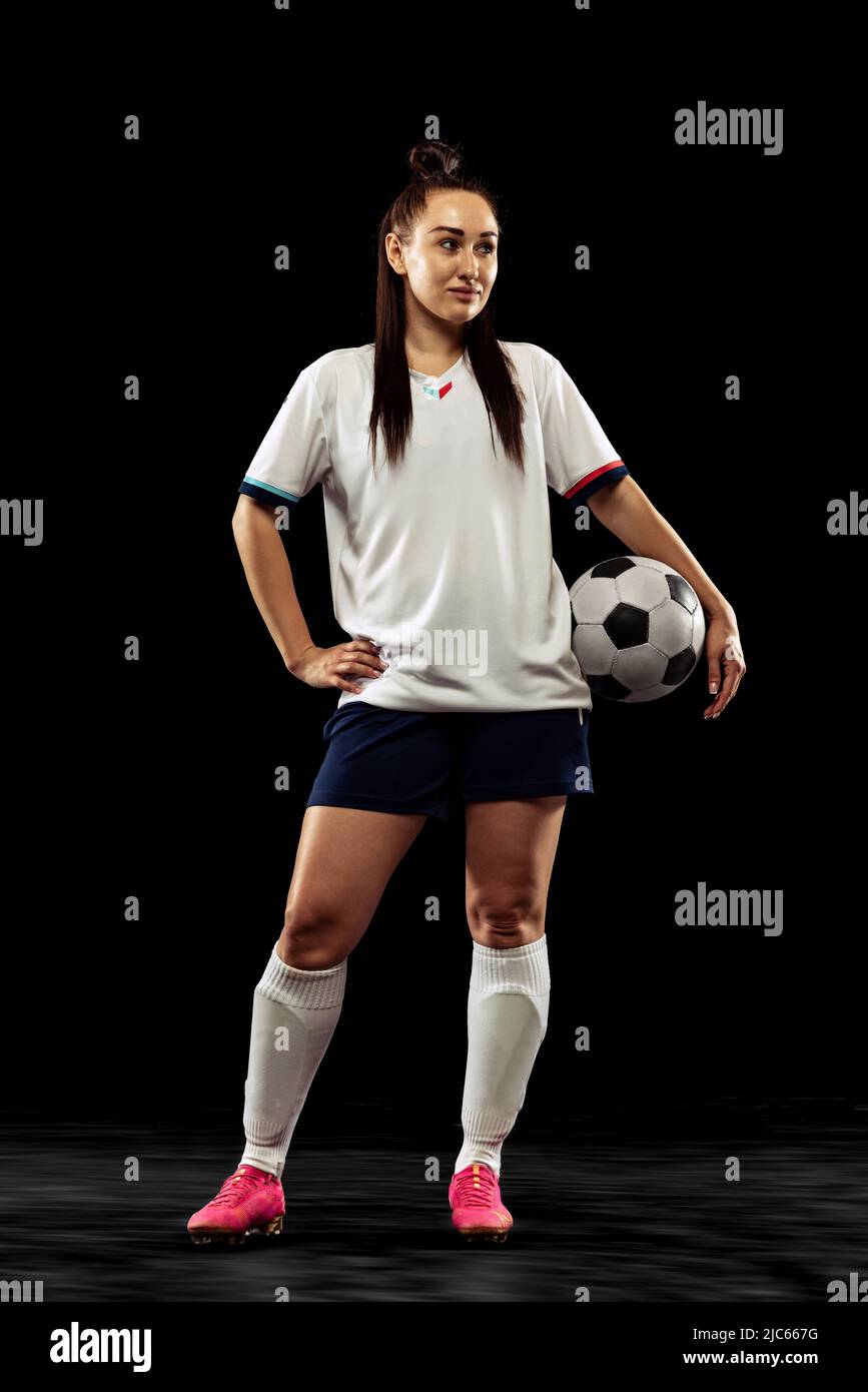 Full-length portrait of sportive girl, female soccer, football player ...
