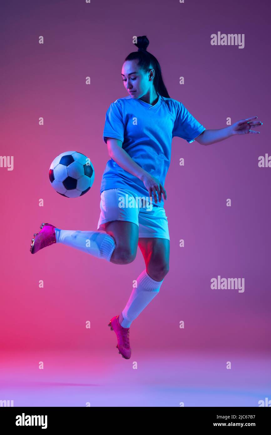 One sportive girl, female soccer player kick in jump football ball ...