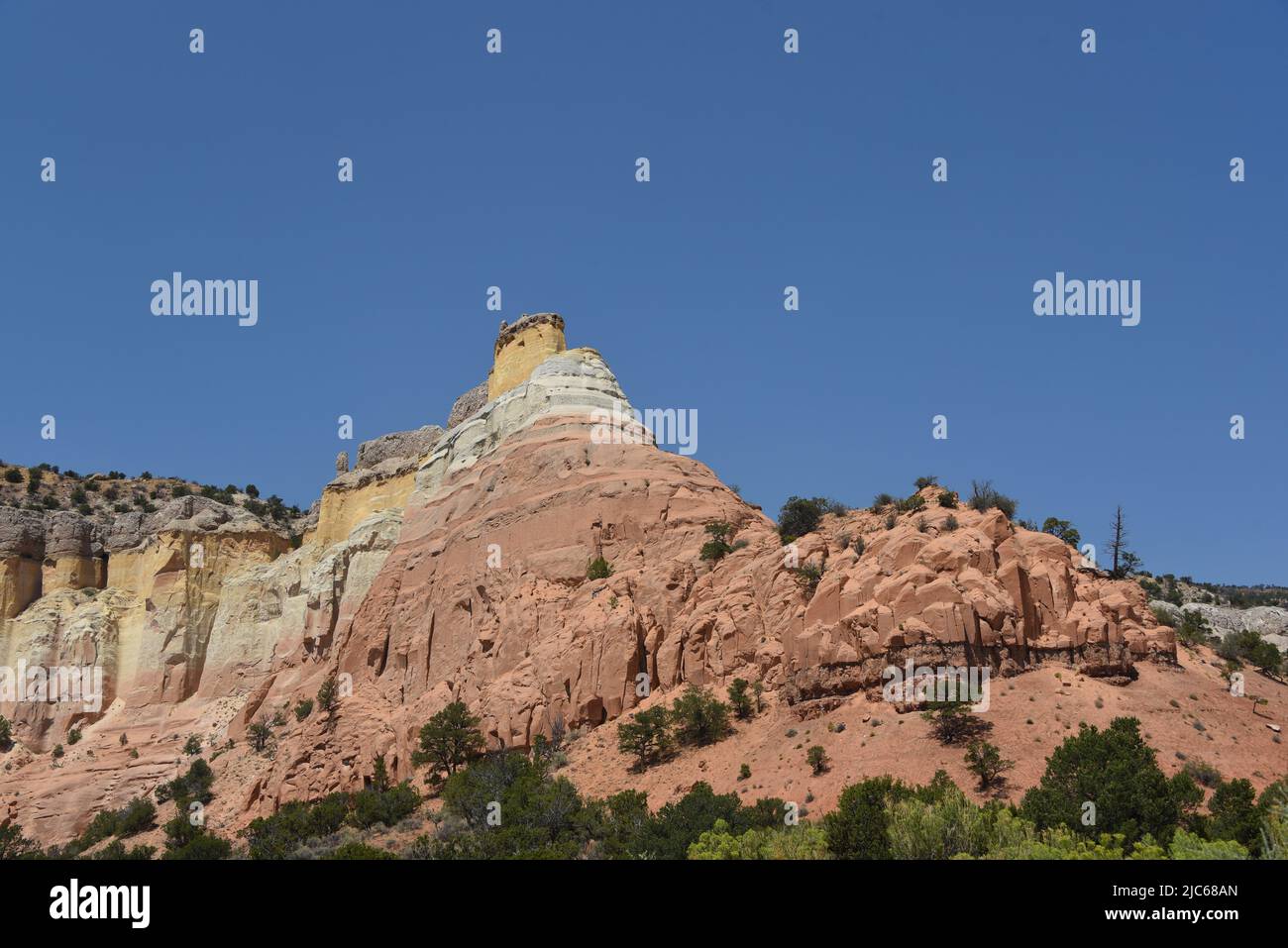 A beautiful desert landscape of red, yellow and white layered sandstone ...