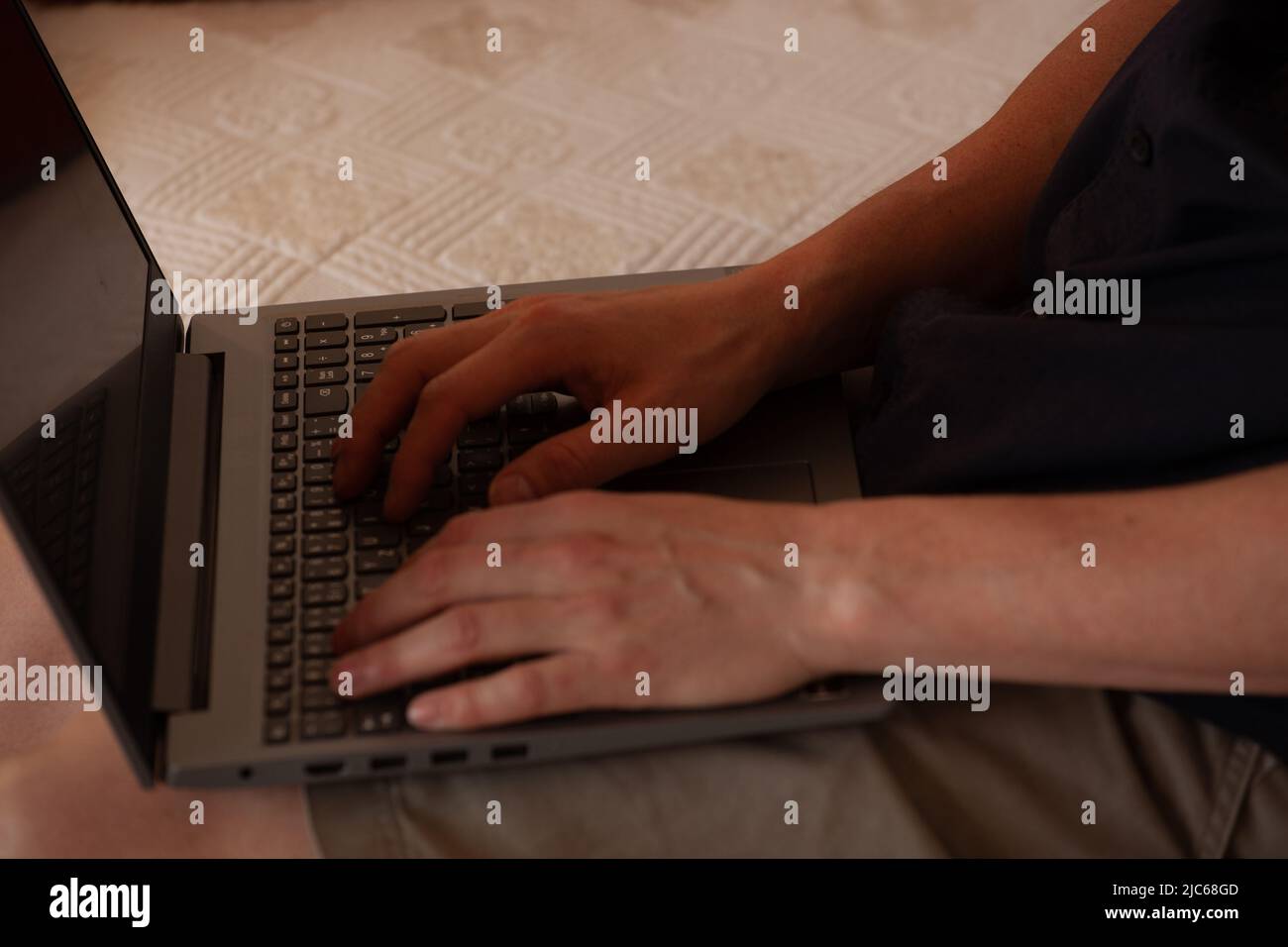 a man's hands on a computer keyboard. a white-skinned man types on the ...