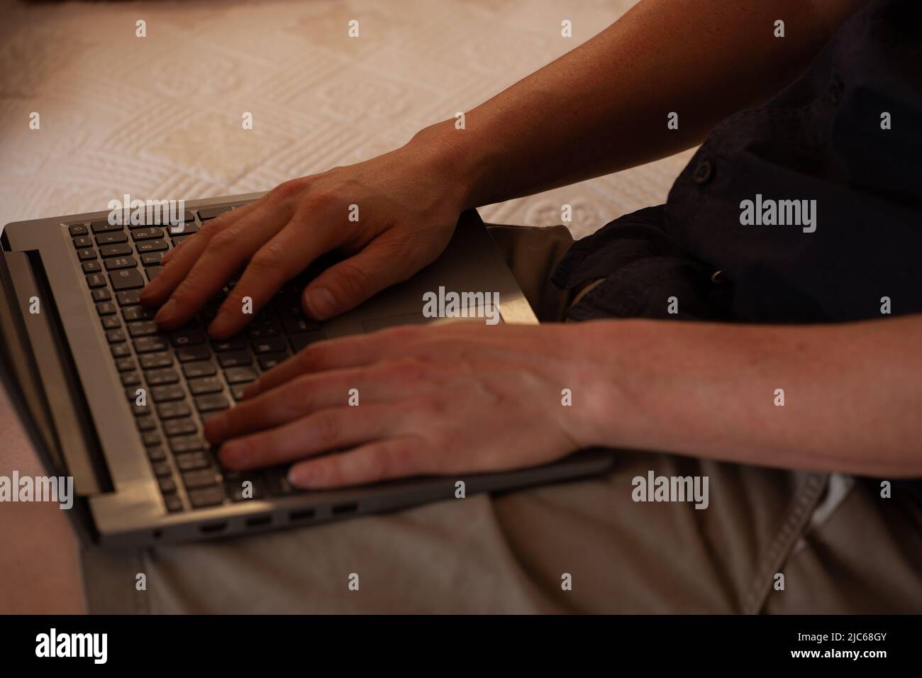 a man's hands on a computer keyboard. a white-skinned man types on the ...