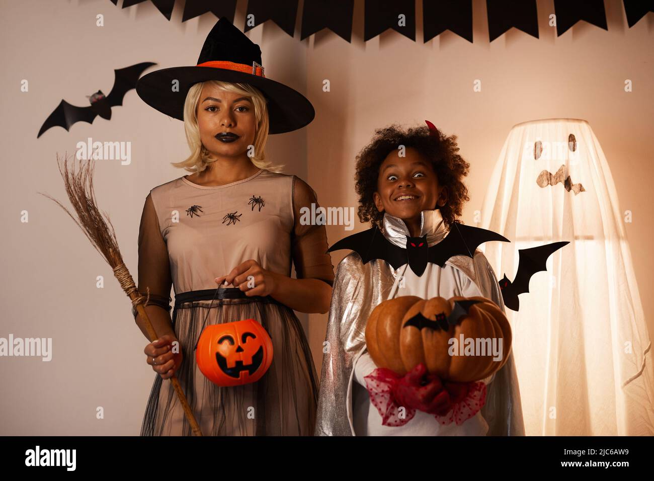 Portrait Of African American Mother And Son Trick Or Treating Together On Halloween They