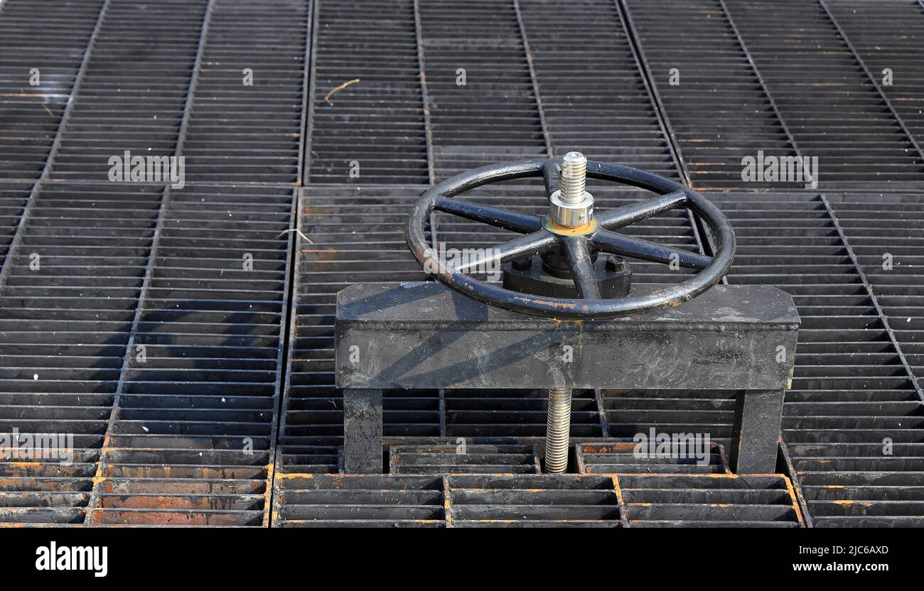 Large cog wheels with control wheel for on-off water gate close-up ...