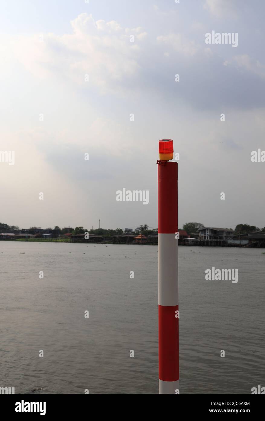 warning lights on steel pole at river bank, close up of a yellow ...