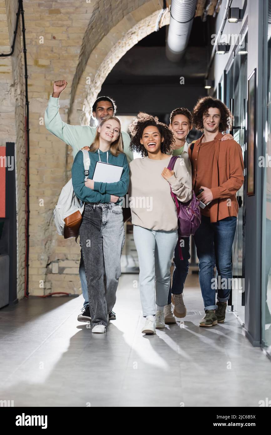 excited african american student showing triumph gesture near ...