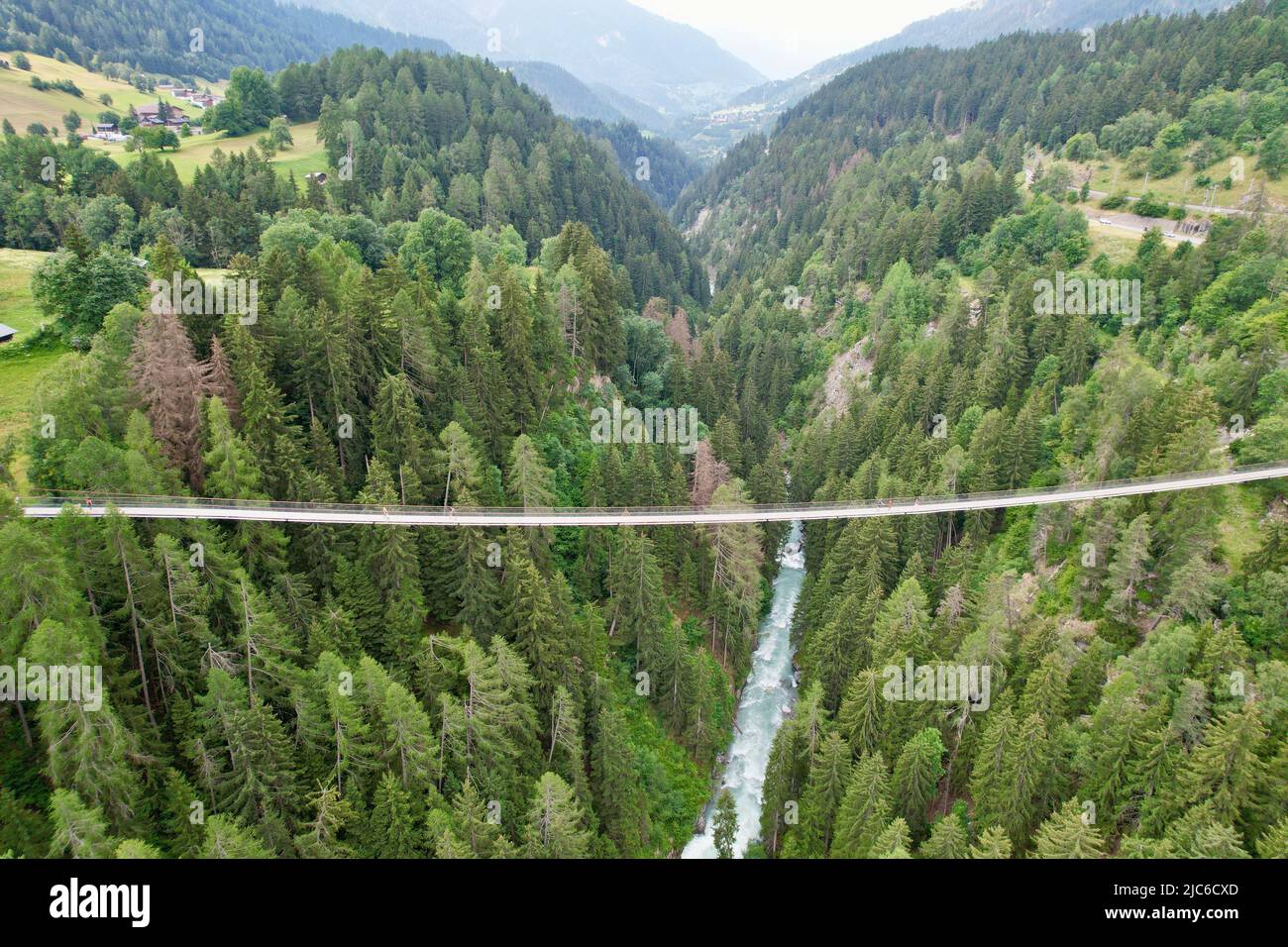 Top drone aerial view on a suspension bridge and a river valley in ...