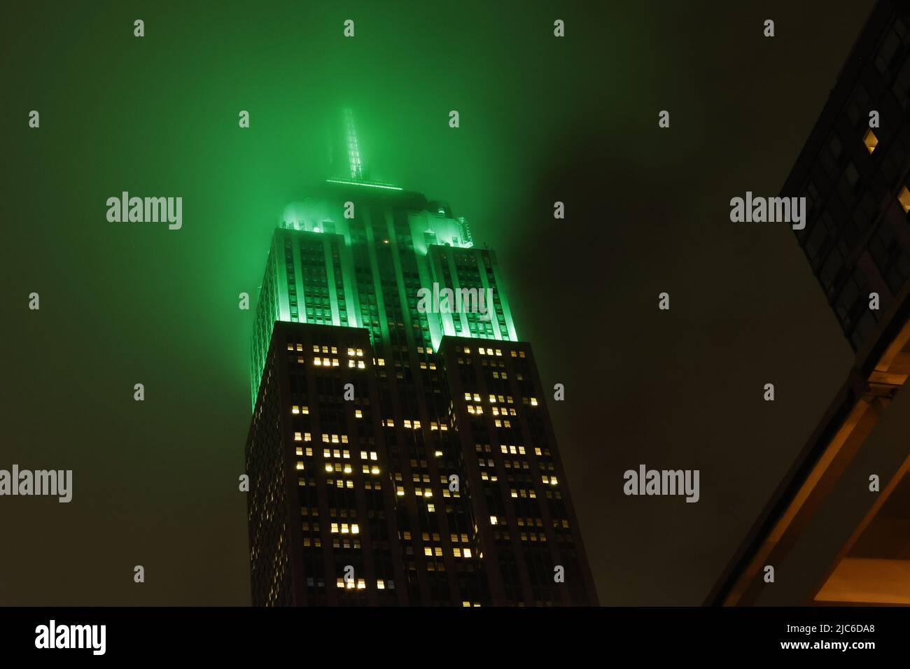 Low angle night view on Empire State building with green lights, Manhattan, New York, USA Stock ...
