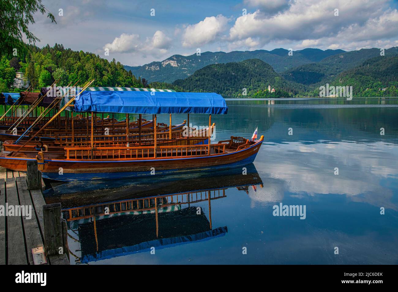 Traditional Pletna boat on the Bled lake. In the background is the ...