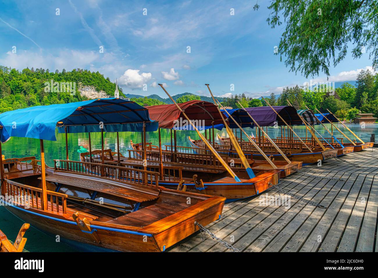 Traditional Pletna boat on the Bled lake. In the background is the ...