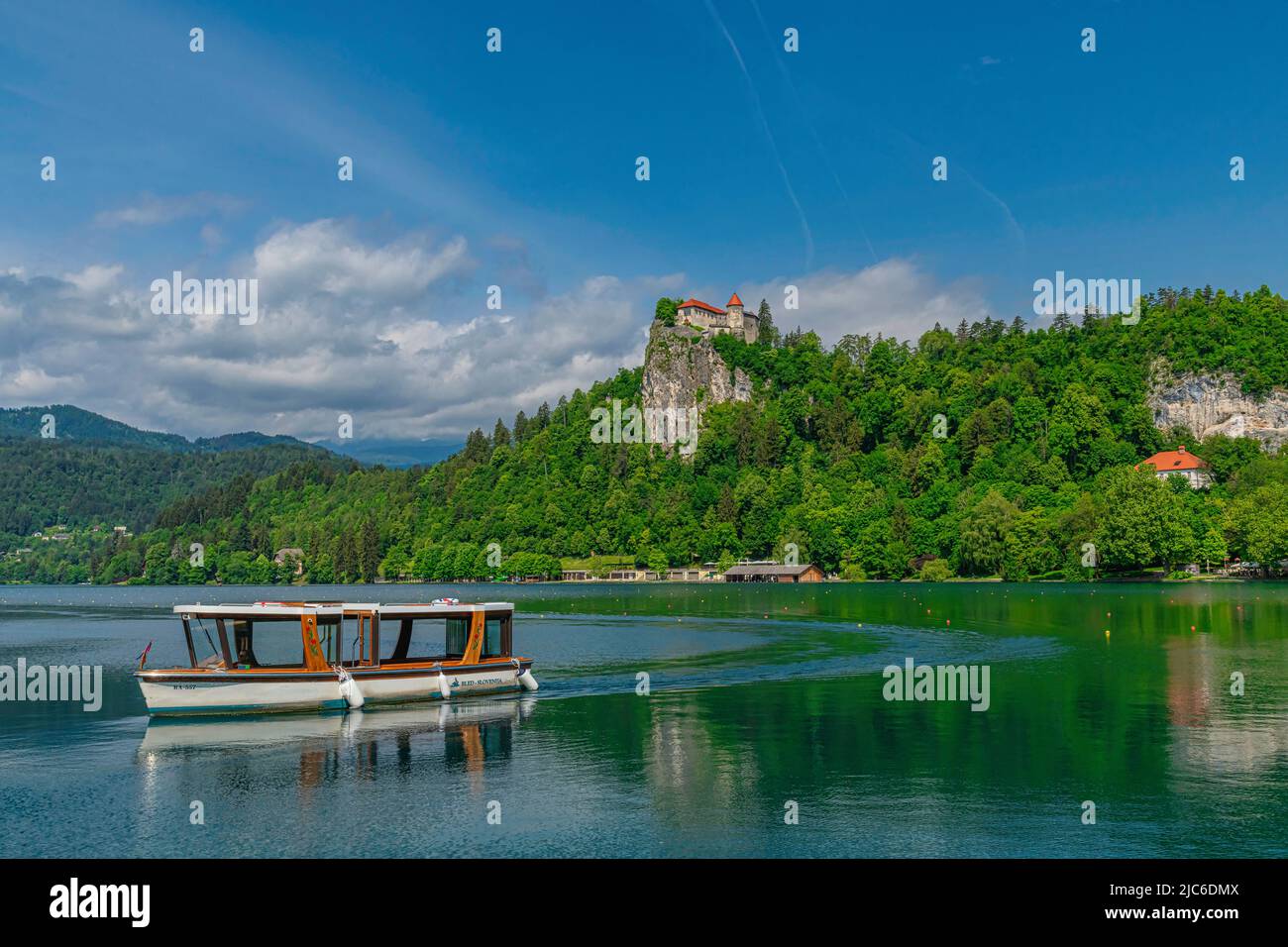 Traditional Pletna boat on the Bled lake. In the background is the ...