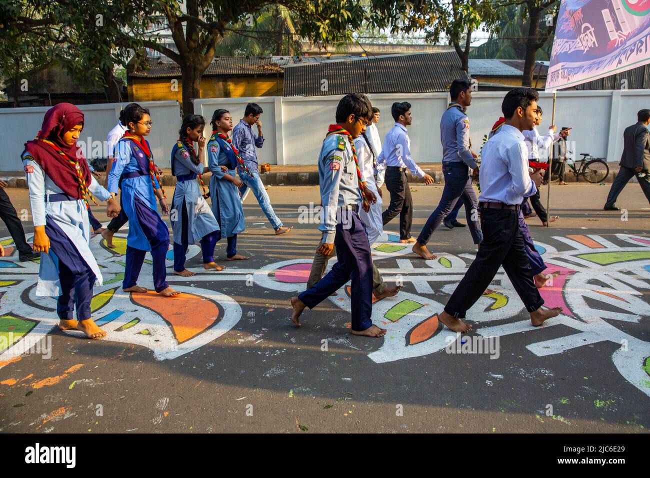 A crowd marches through the street to commemorate the sacrifices of the ...