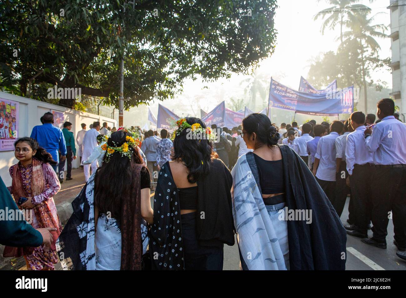 A crowd marches through the street to commemorate the sacrifices of the ...