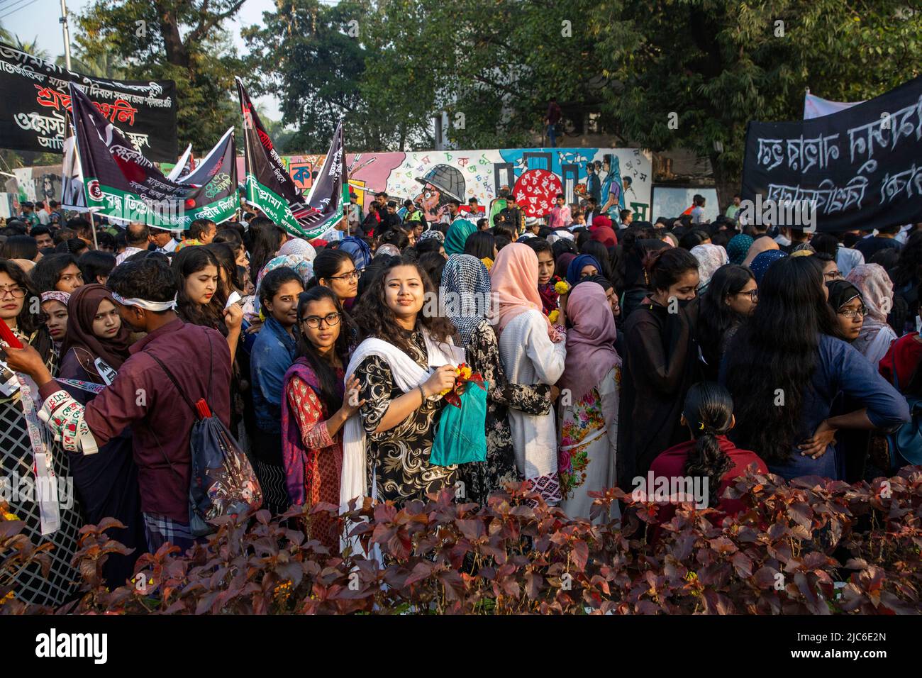 A crowd marches through the street to commemorate the sacrifices of the ...