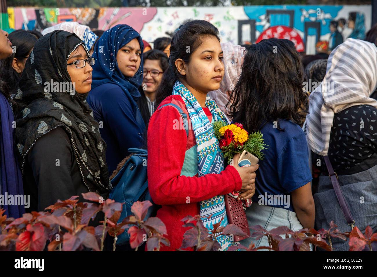 A crowd marches through the street to commemorate the sacrifices of the ...