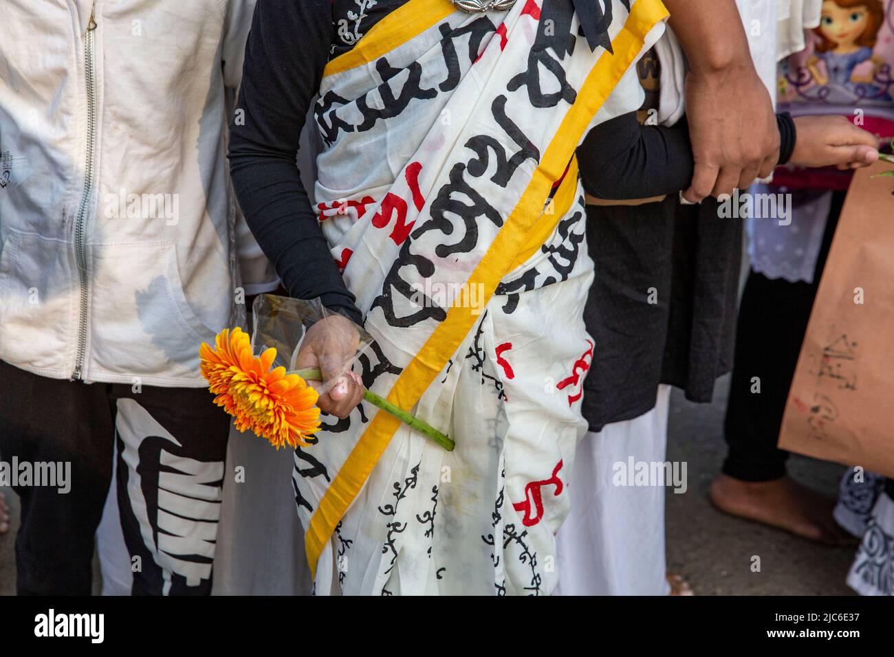 A crowd marches through the street to commemorate the sacrifices of the ...
