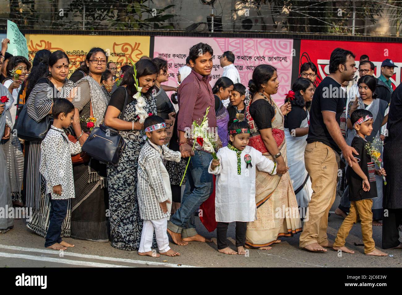 A crowd marches through the street to commemorate the sacrifices of the ...