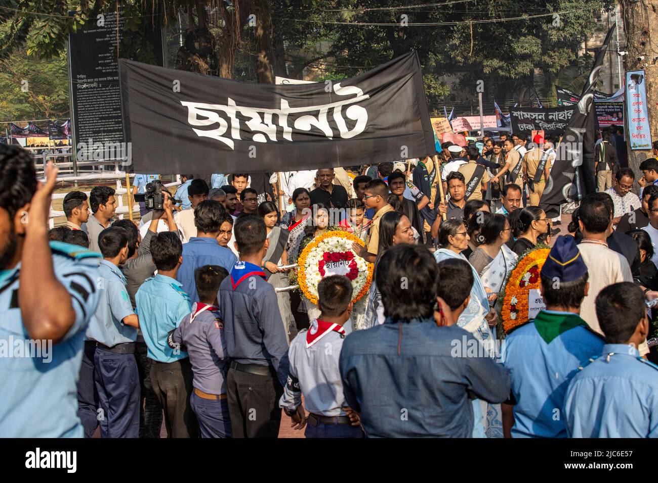 A crowd marches through the street to commemorate the sacrifices of the ...