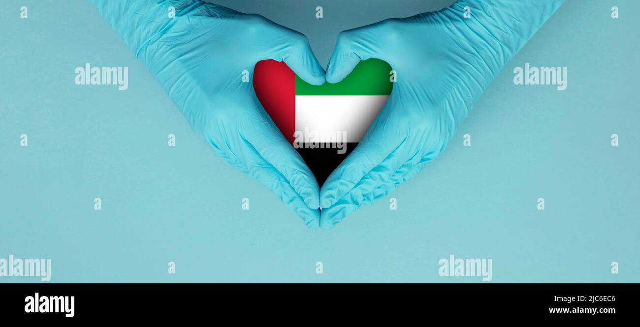 Doctors hands wearing blue surgical gloves making hear shape symbol ...