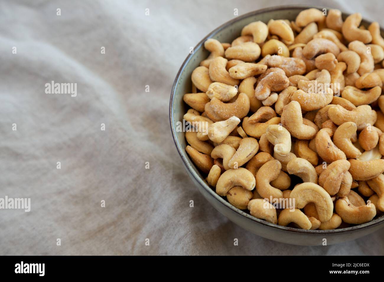 Homemade Roasted and Salted Cashews in a Bowl, side view. Copy space ...
