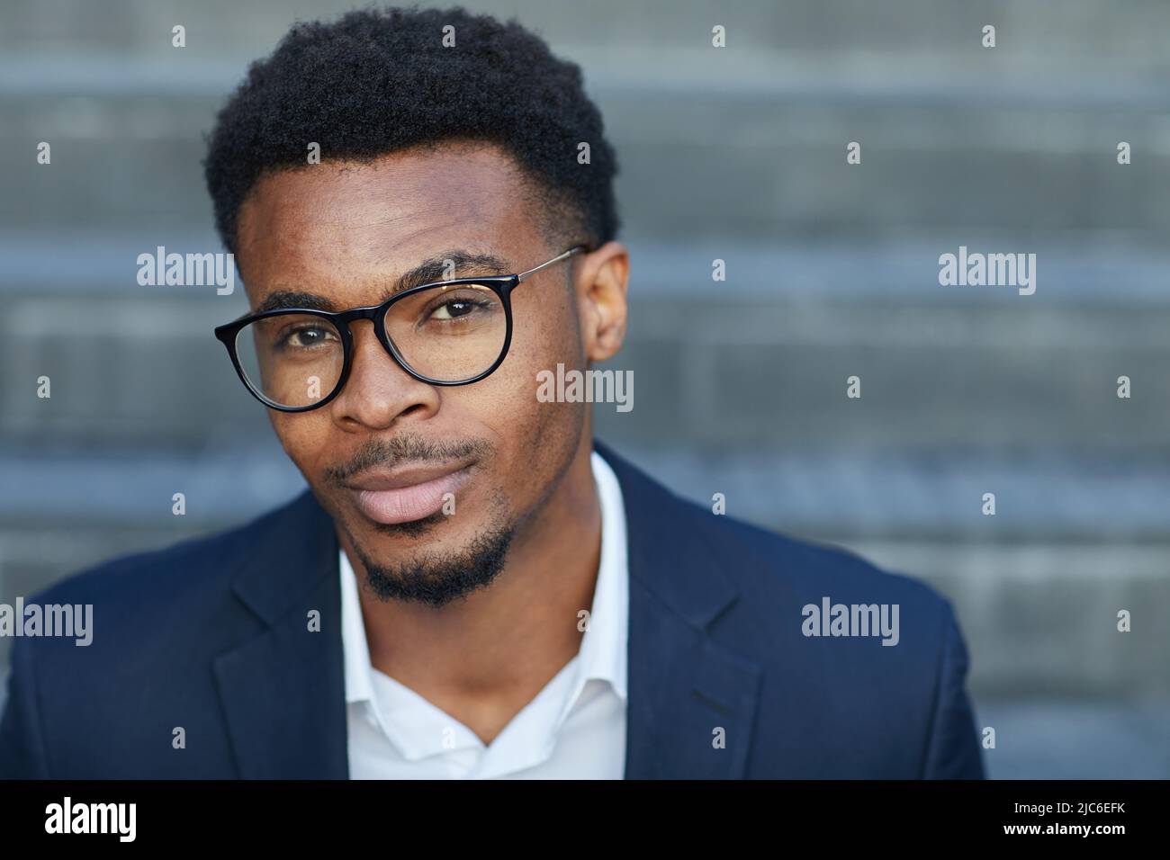 Portrait of content handsome young smart African-American man in ...