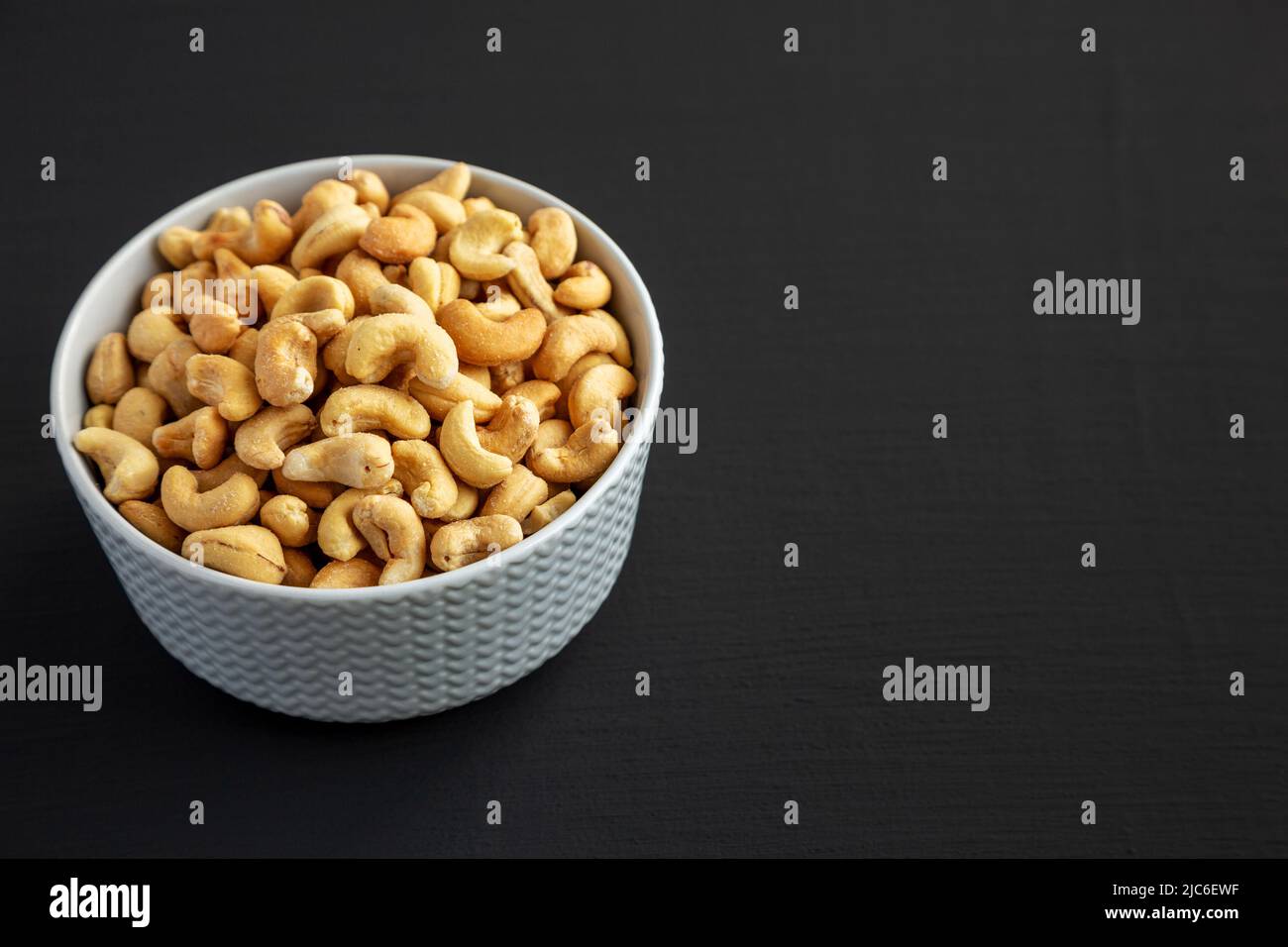 Homemade Roasted and Salted Cashews in a Bowl, side view. Copy space ...