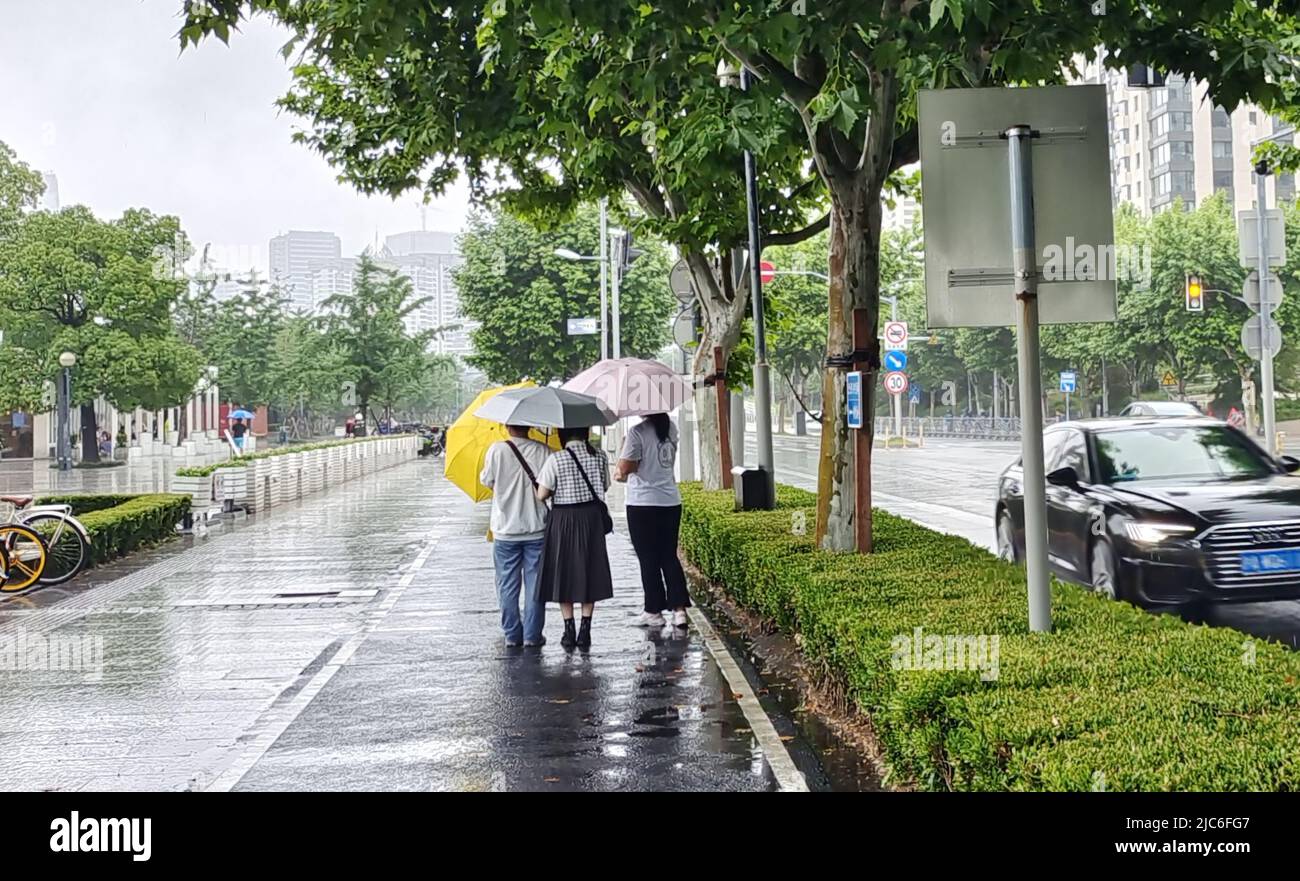SHANGHAI, CHINA - JUNE 5, 2022 - People travel in the rain in Shanghai ...