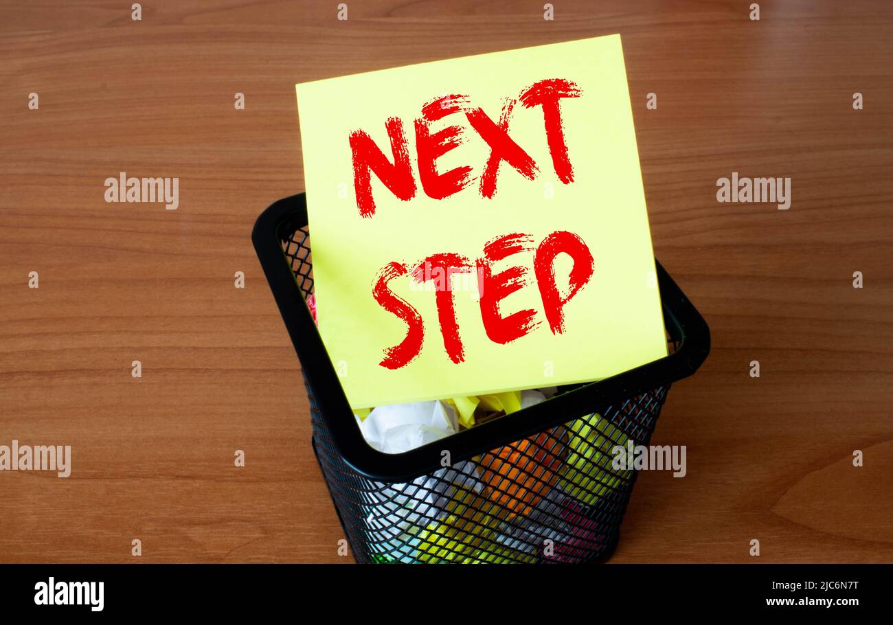 Next Step sign with clouds and sky background Stock Photo - Alamy