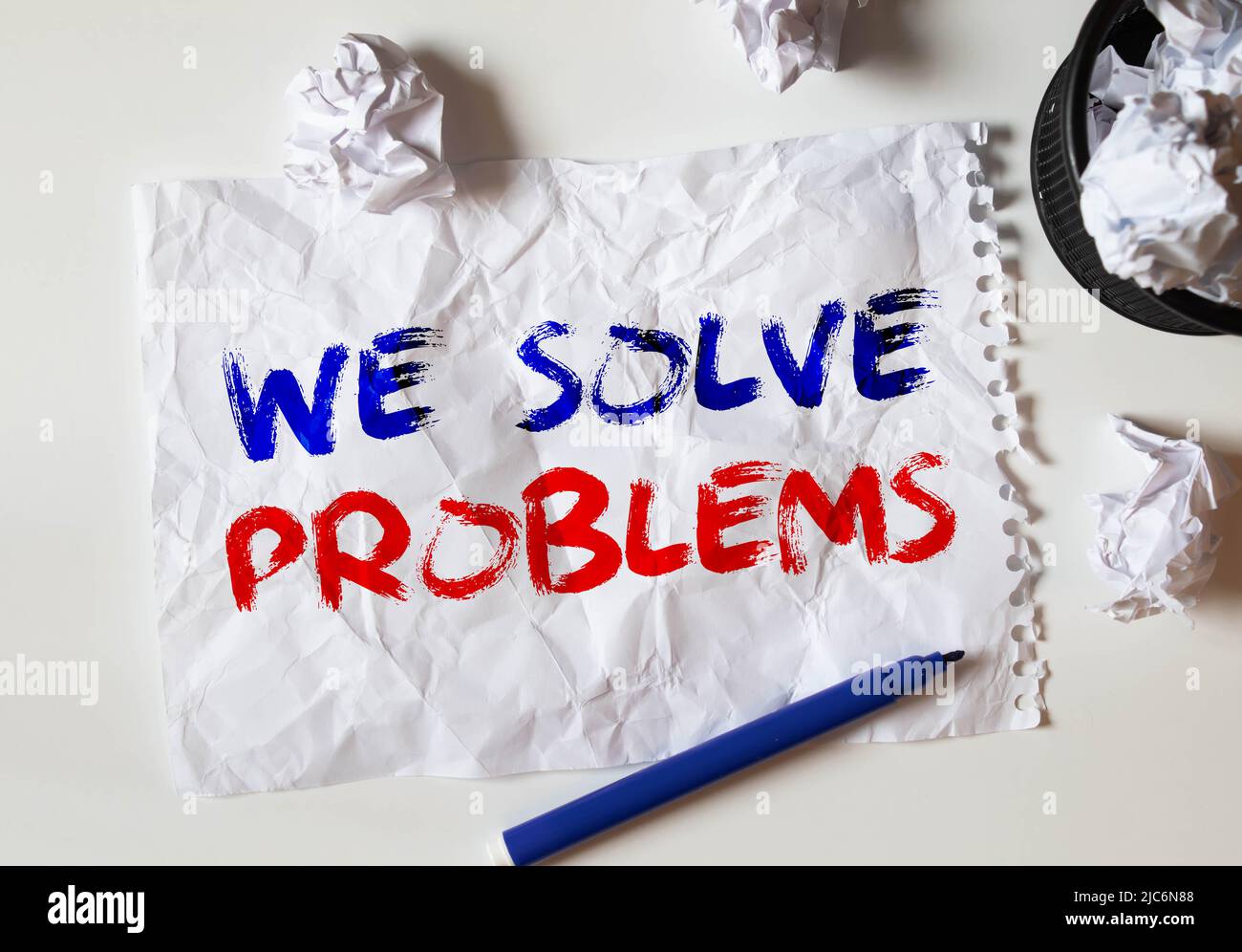 We solve problems inscription on crumpled paper Stock Photo - Alamy