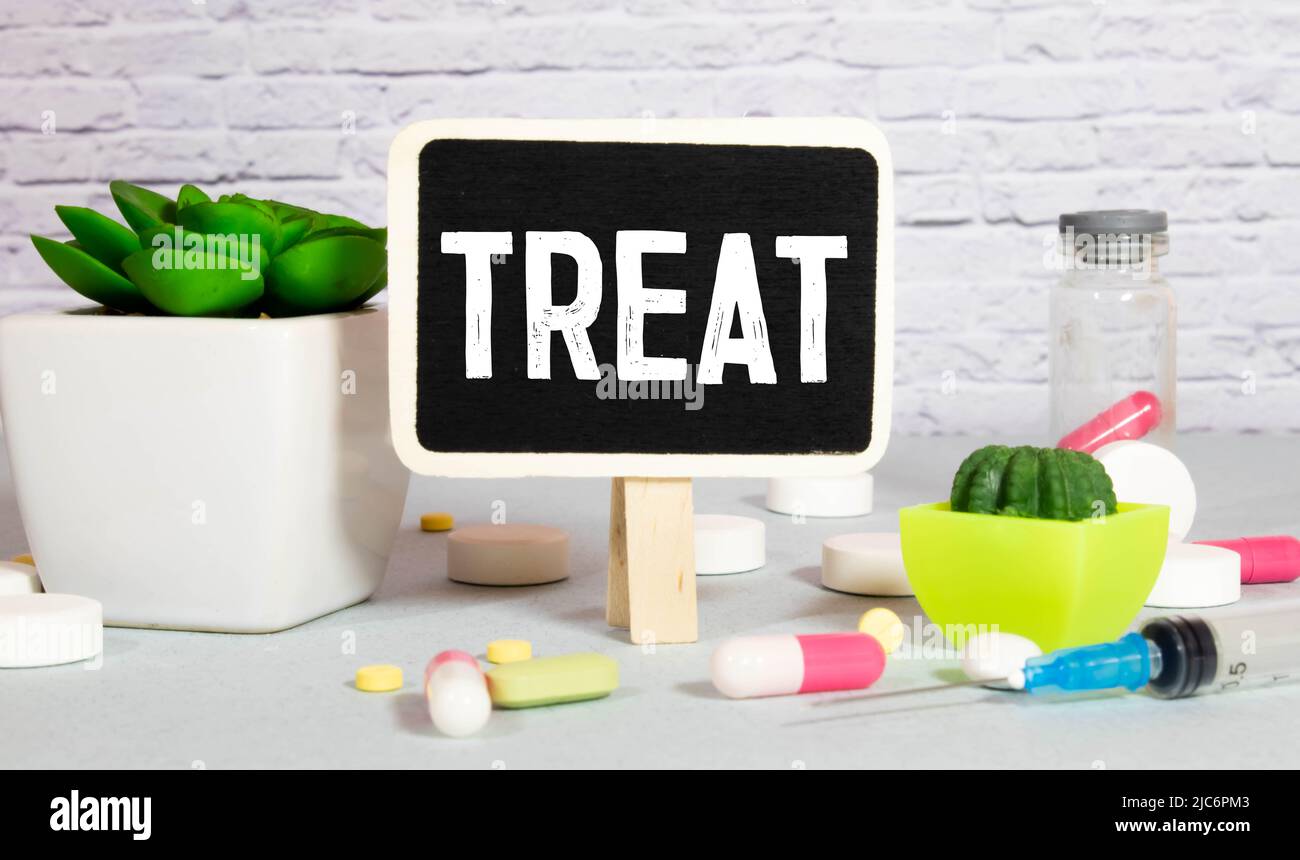 Treat word written on wooden blocks and stethoscope on light blue ...