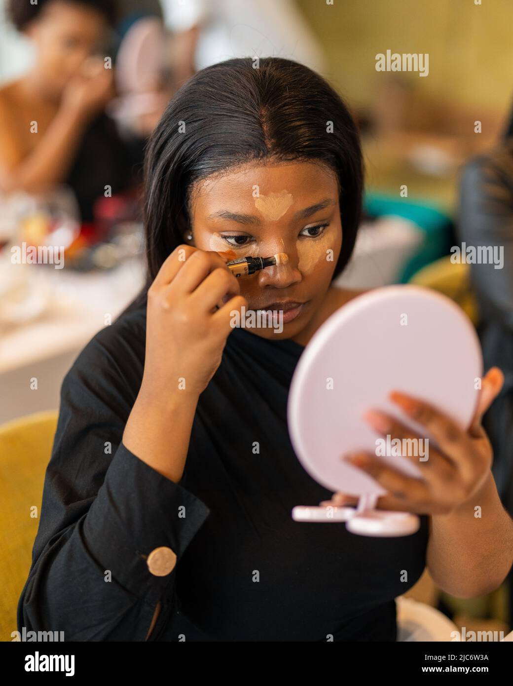 Portrait of a lady applying makeup during a makeup masterclass Stock ...