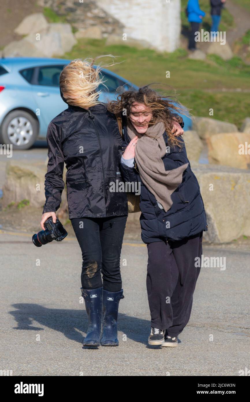 People walking in high winds brought by Storm Eunice in Newquay in ...