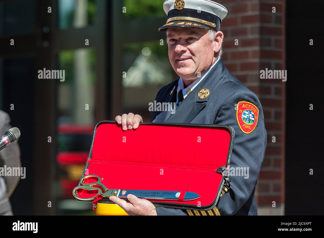 Chief Robert Hart, Acton Fire Dept, showing special scissors at ribbon ...