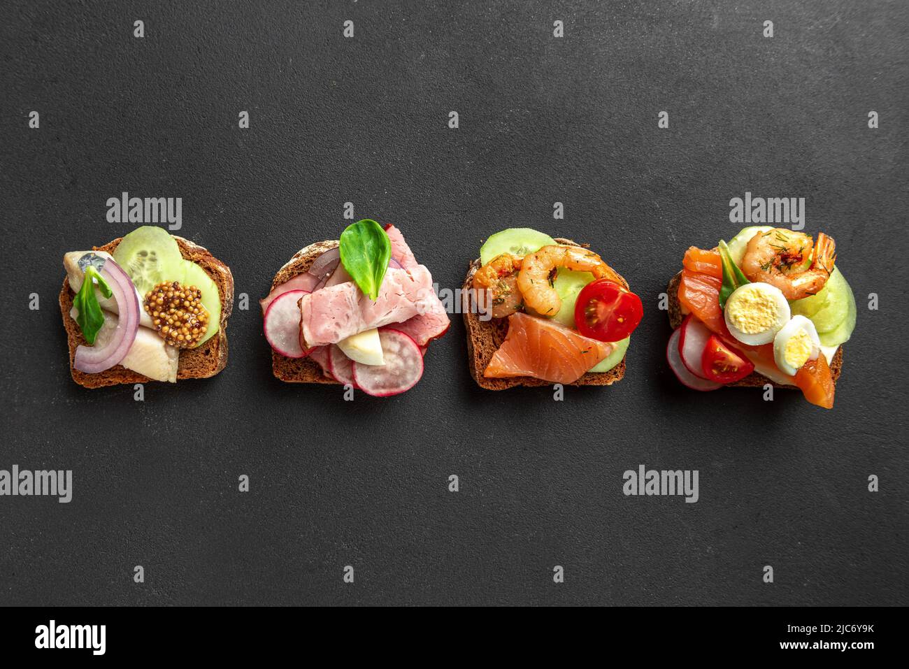 Snack set on a black background top view. Danish Snack Sets Stock Photo ...