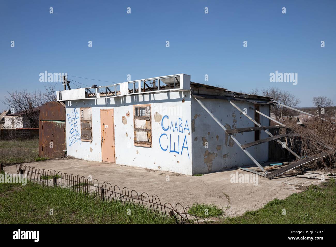 Bombed house, in Cyrillic ironic inscription Glory of the USA. Avdiivka ...