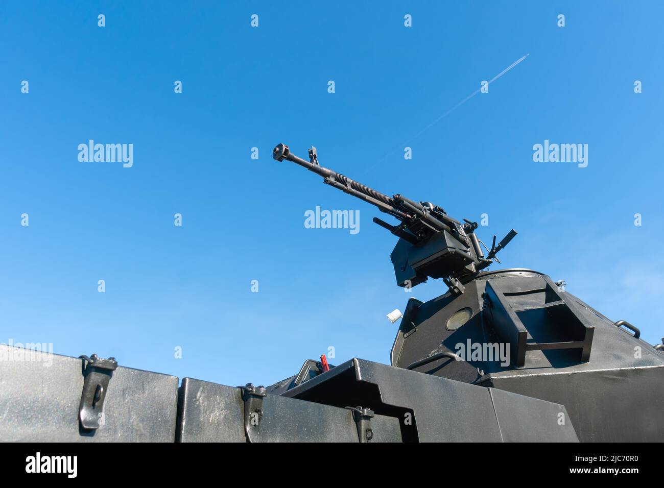 Close-up of a machine gun on an armored personnel carrier against a ...