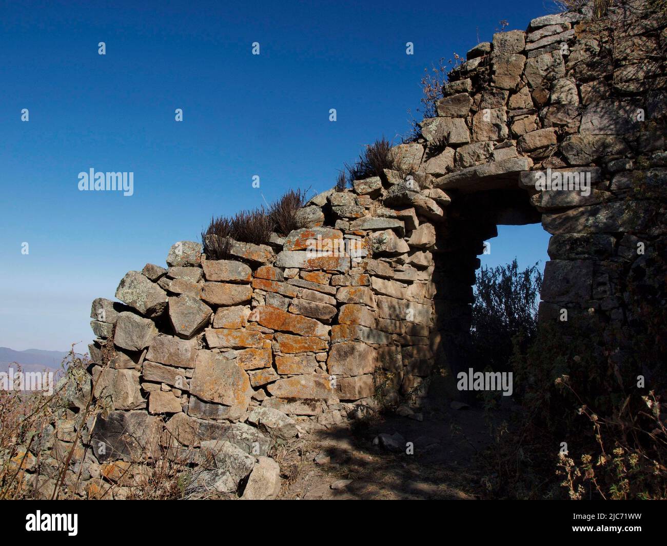 Gate at the ruins of the stone citadel of Rupac in the Peruvian Andes ...