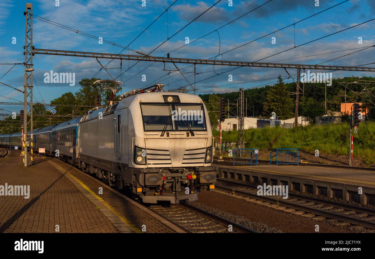 Prague Liben station with fast electric train in spring sunny color ...