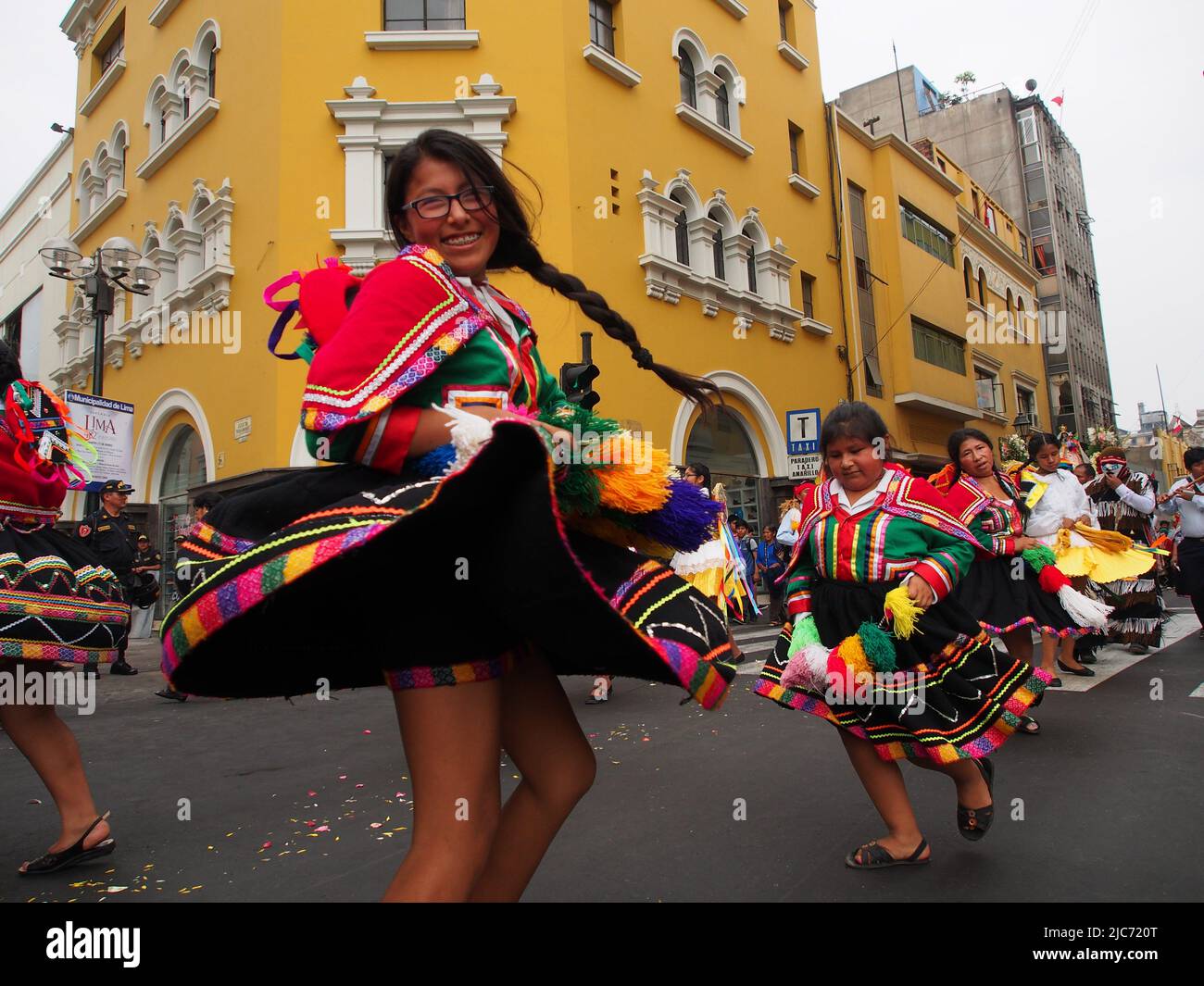 Women in typical costumes dancing in the procession. Hundreds of people ...